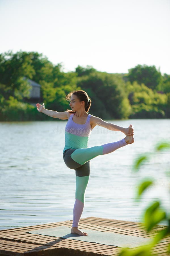 Young Healthy Woman Practicing Yoga at Sunset. Stock Image - Image of ...