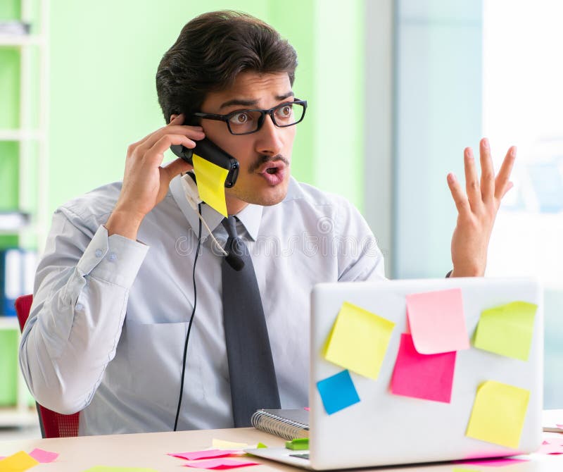 Young Help Desk Operator Working in Office with Many Conflicting Stock ...