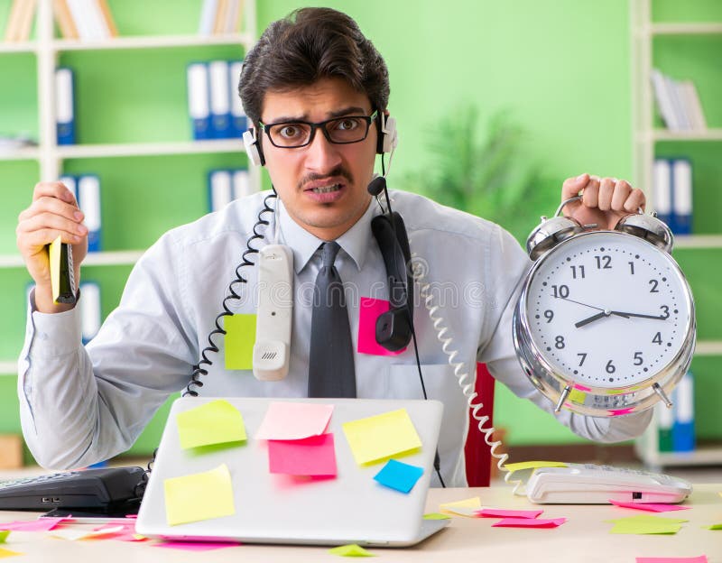 Young Help Desk Operator Working in Office with Many Conflicting Stock ...