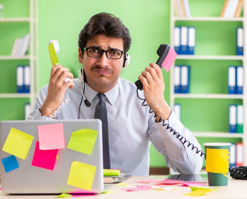 Young Help Desk Operator Working in Office with Many Conflicting Stock ...