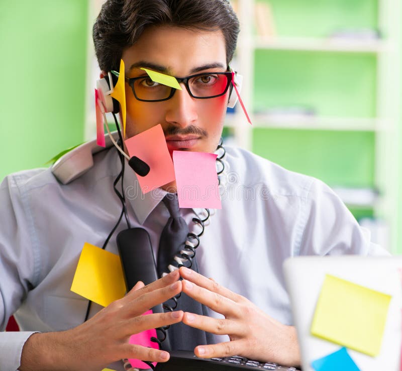 Young Help Desk Operator Working in Office with Many Conflicting Stock ...