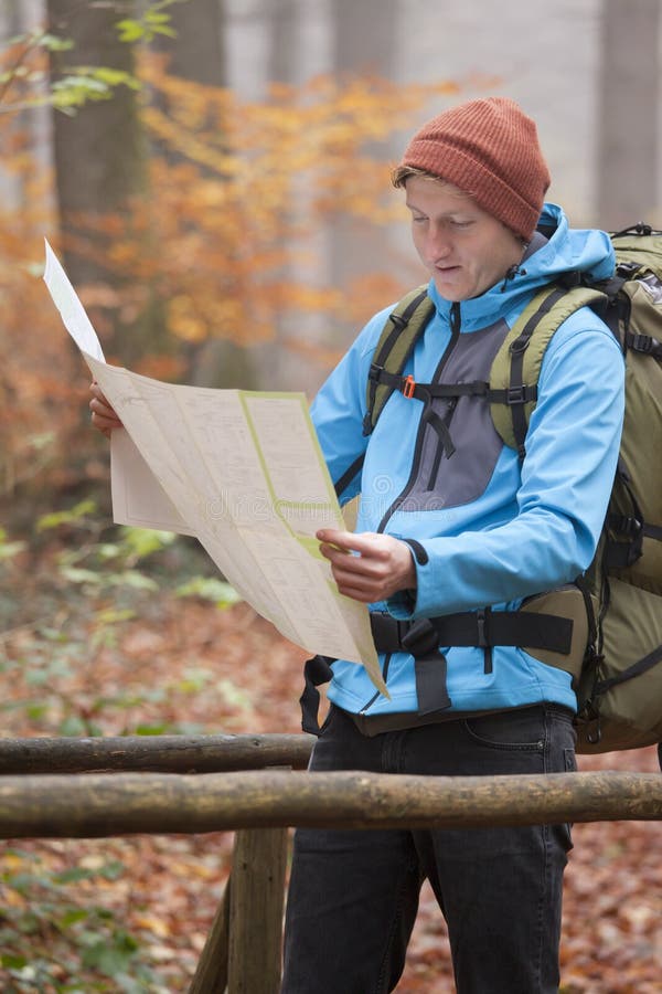 Young Hiker Looking at a Map in a Colorful Forest in Fall Stock Photo ...