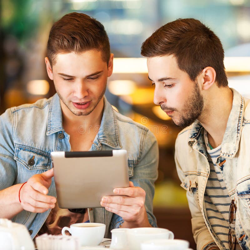 Young Hipster Guy Sitting in a Cafe Chatting and Drinking Coffe Stock ...