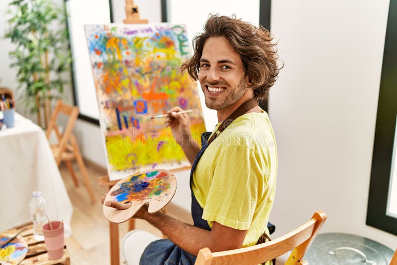 Young Hispanic Artist Man Smiling Happy Drawing at Art Studio Stock ...