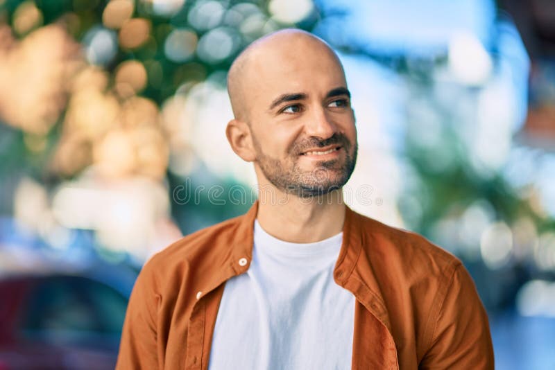 Young Hispanic Bald Man Smiling Happy Standing at the City Stock Photo ...