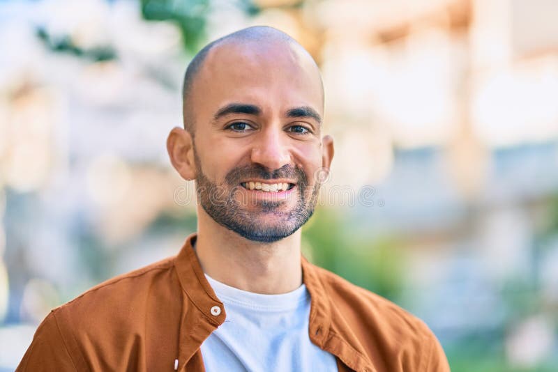 Young Hispanic Bald Man Smiling Happy Standing at the City Stock Photo ...
