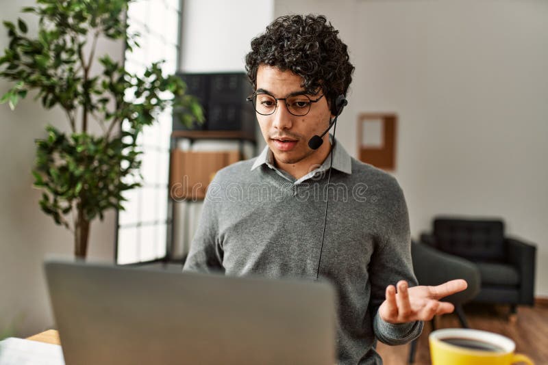 Young Hispanic Call Center Agent Man Having Video Call at the Office ...