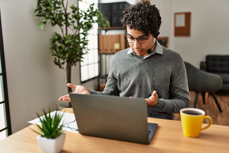 Young Hispanic Call Center Agent Man Having Video Call at the Office ...