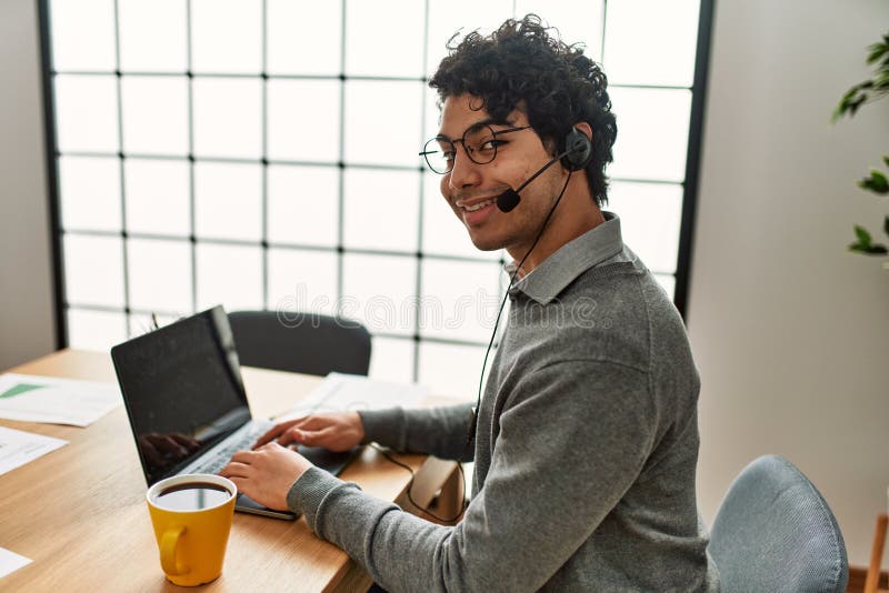 Young Hispanic Call Center Agent Man Smiling Happy Working at the ...