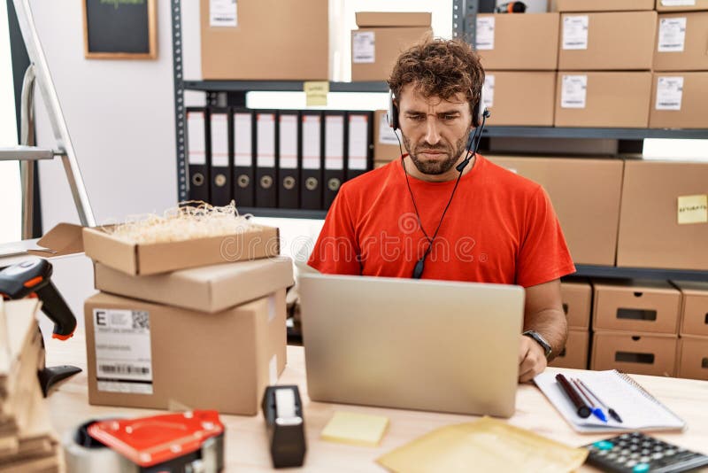 Young Hispanic Call Center Agent Man Working at Warehouse Depressed and ...