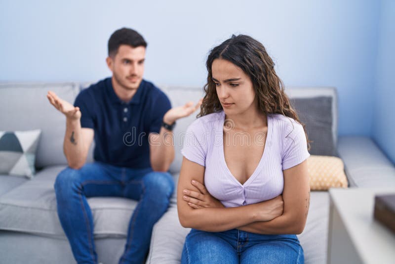 Young Hispanic Couple Arguing Sitting on Sofa at Home Stock Photo ...
