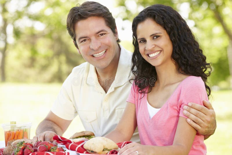 Young Hispanic Couple Enjoying Picnic in Park Stock Photo - Image of ...