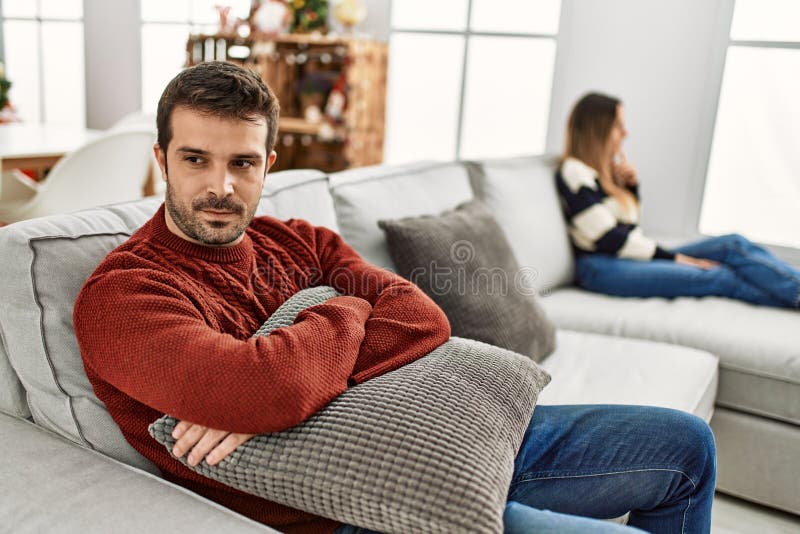 Young Hispanic Couple with Problems Sitting on the Sofa in Silence at ...