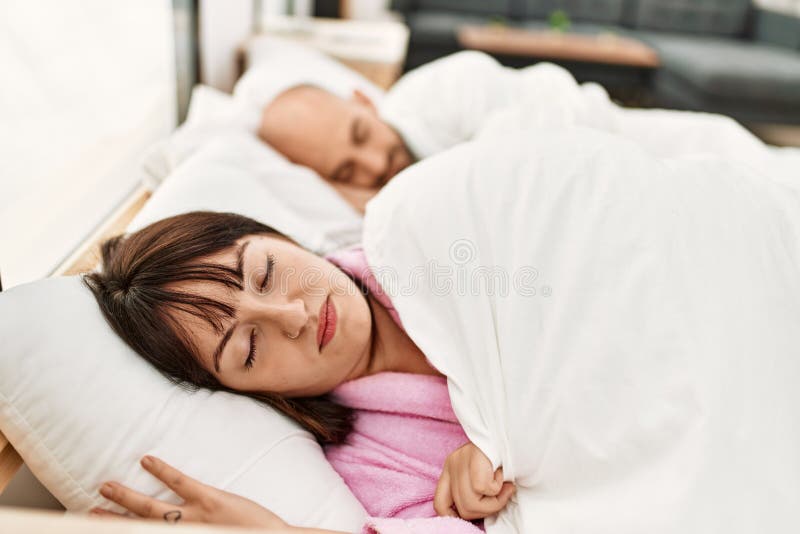 Young Hispanic Couple Sleeping on the Bed at Bedroom Stock Photo ...