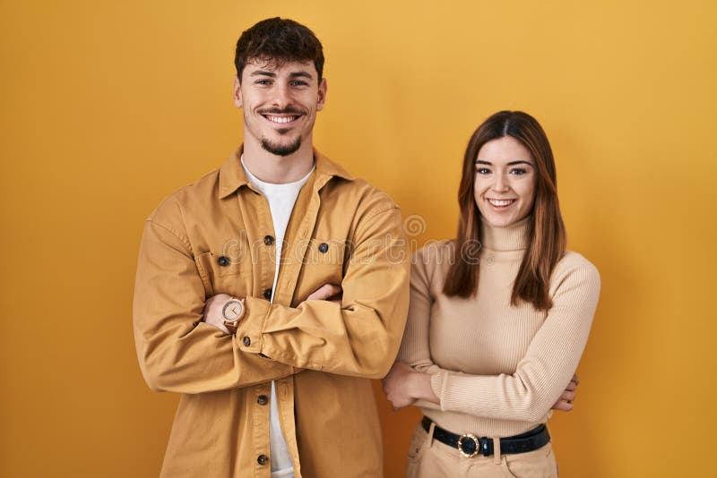 Young Hispanic Couple Standing Over Yellow Background Happy Face ... Young Hispanic Couple Standing Over Yellow Background Happy Face ...