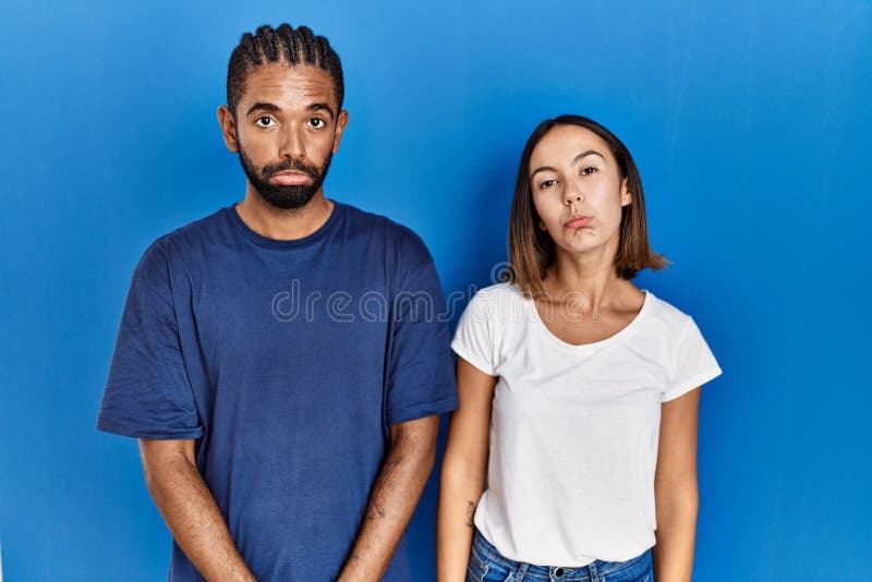 Young Hispanic Couple Standing Together Depressed and Worry for ...