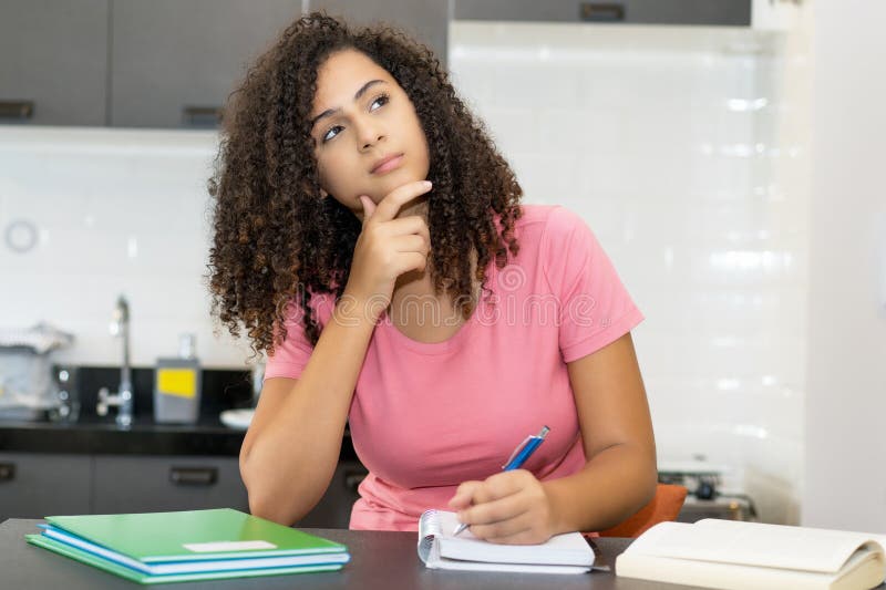 Young Hispanic Female Student Thinking about a Problem Stock Image ...