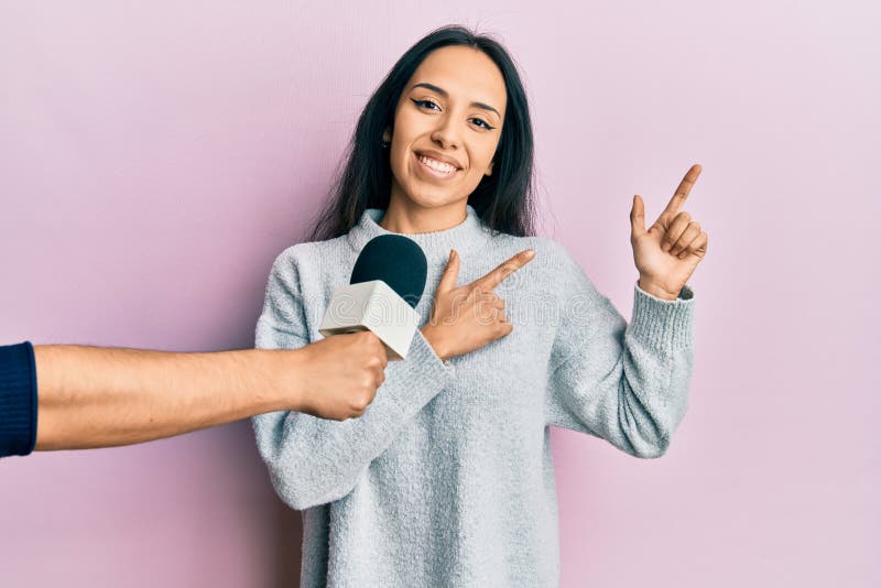Young Hispanic Girl Being Interviewed by Reporter Holding Microphone ...