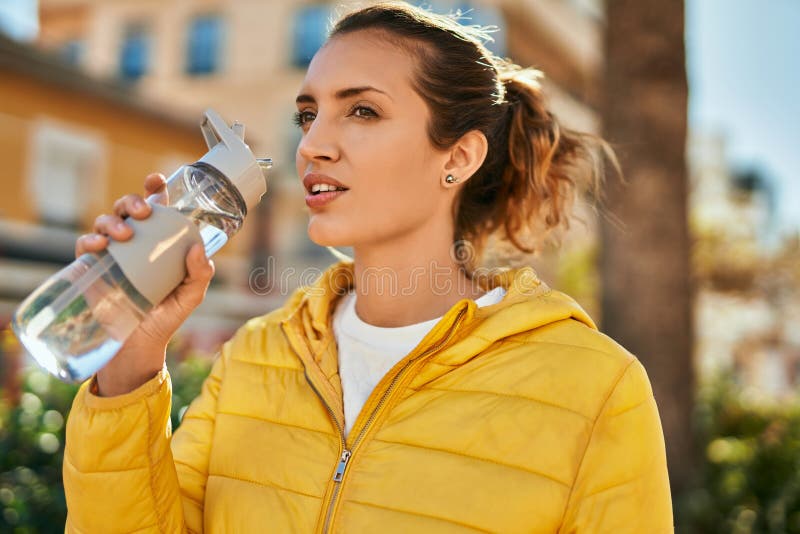 Young Hispanic Girl with Relaxed Expression Drinking Bottle of Water at ...