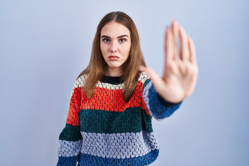 Young Hispanic Girl Standing Over Blue Background Doing Stop Sing with ...