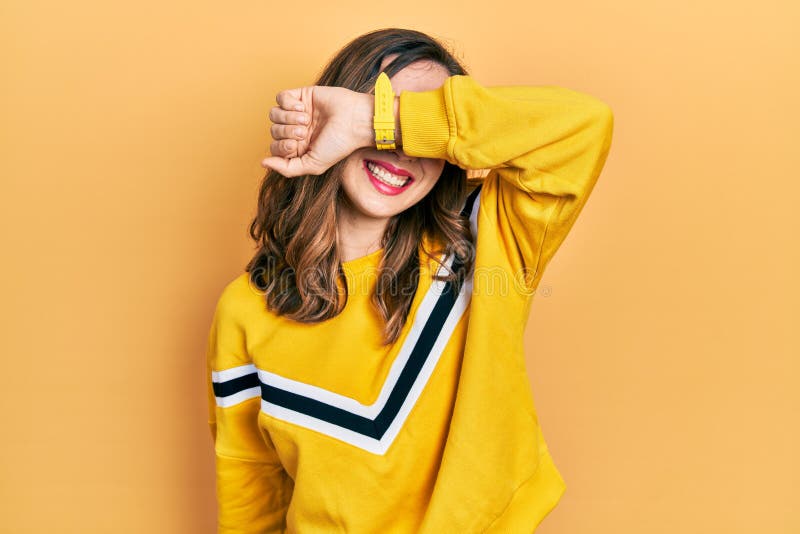 Young Hispanic Girl Wearing Casual Clothes Covering Eyes With Arm