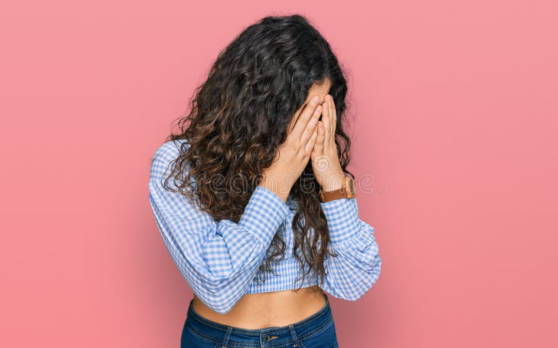 Young Hispanic Girl Wearing Casual Clothes With Sad Expression Covering