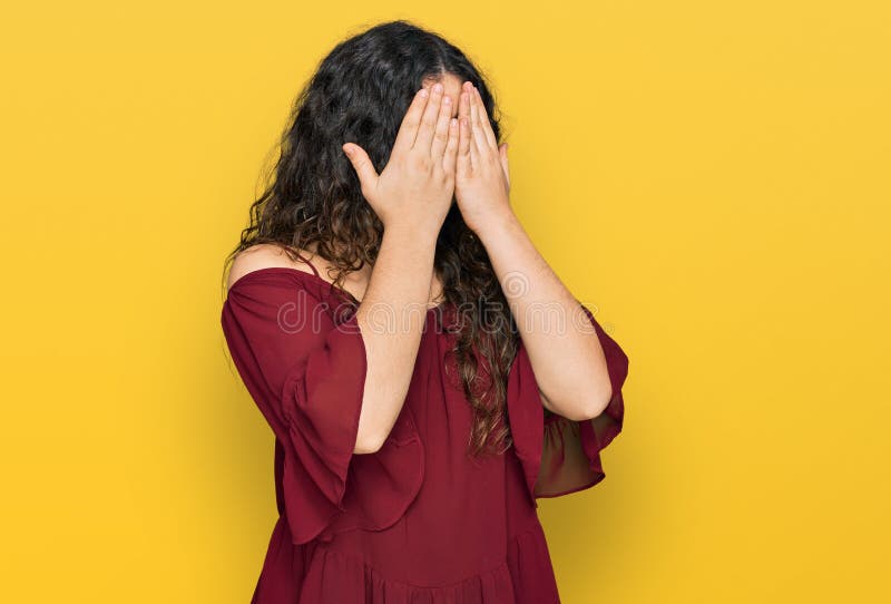 Young Hispanic Girl Wearing Casual Clothes With Sad Expression Covering