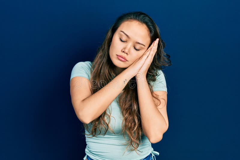 Young Hispanic Girl Wearing Casual Clothes Sleeping Tired Dreaming And