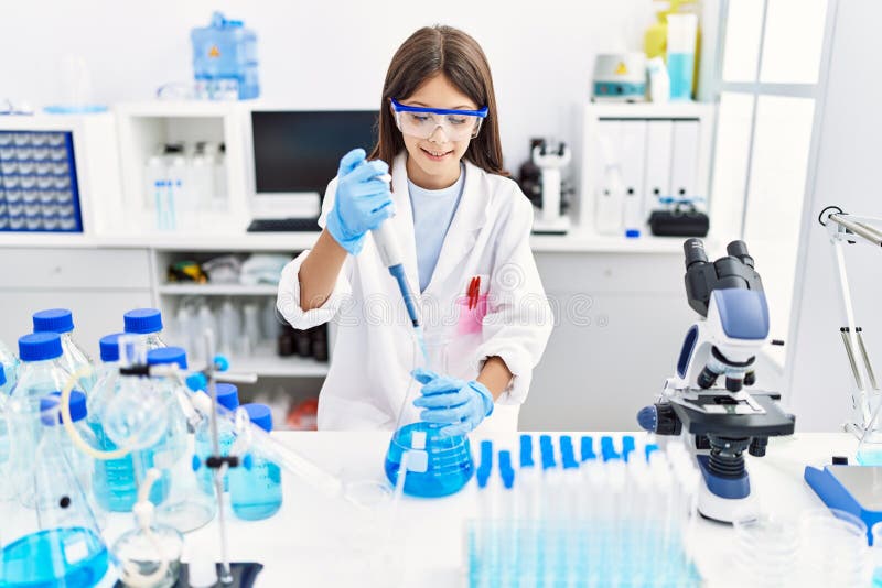Young Hispanic Girl Working Using Pipette at Laboratory Stock Image ...