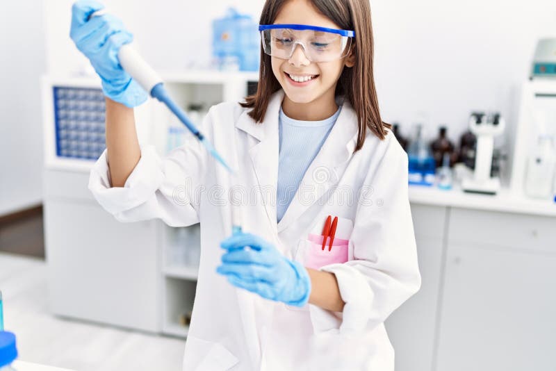 Young Hispanic Girl Working Using Pipette at Laboratory Stock Photo ...