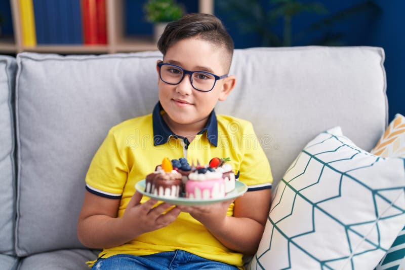 Young Hispanic Kid Holding Cake Sweets Winking Looking at the Camera ...