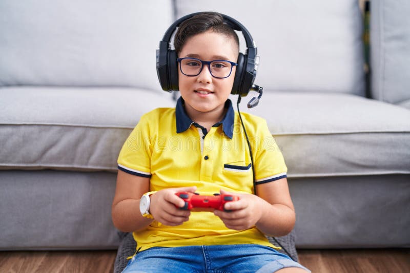 Young Hispanic Kid Playing Video Game Holding Controller Wearing ...