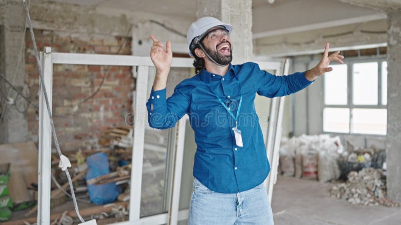 Young Hispanic Man Architect Smiling Confident Dancing at Construction ...