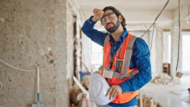 Young Hispanic Man Architect Sweating at Construction Site Stock Photo ...