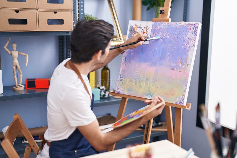 Young Hispanic Man Artist Sitting on Back View Drawing at Art Studio ...