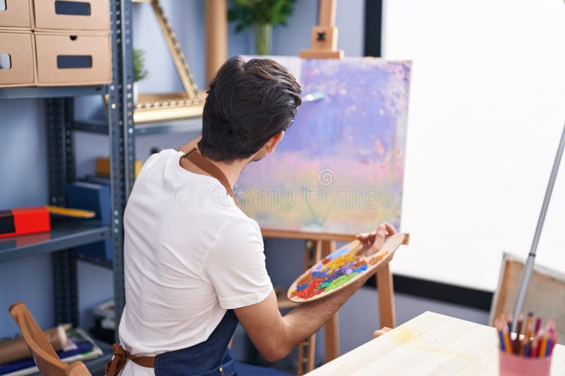 Young Hispanic Man Artist Sitting on Back View Drawing at Art Studio ...