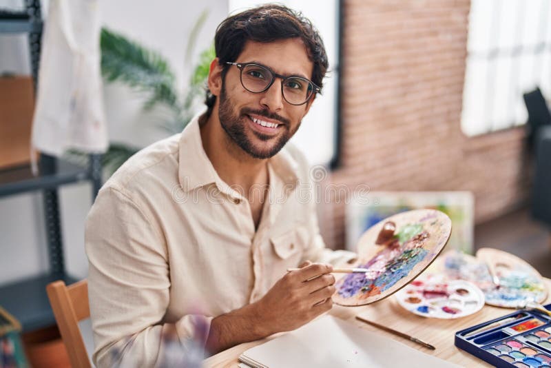 Young Hispanic Man Artist Smiling Confident Drawing on Notebook at Art ...