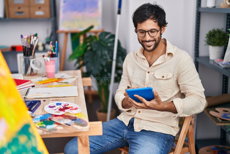 Young Hispanic Man Artist Smiling Confident Using Touchpad at Art ...