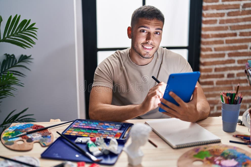 Young Hispanic Man Artist Smiling Confident Using Touchpad at Art ...