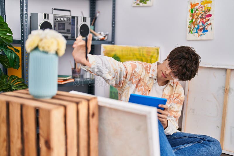 Young Hispanic Man Artist Using Touchpad Drawing at Art Studio Stock ...