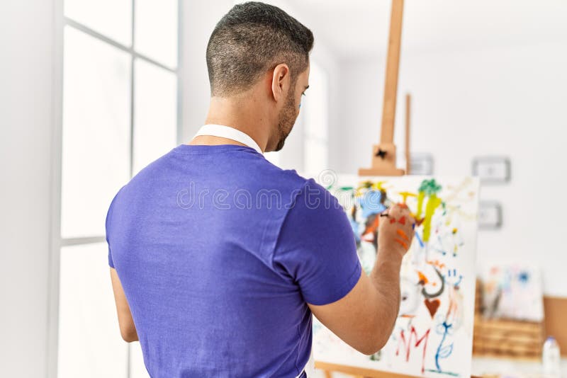 Young Hispanic Man on Back View Drawing at Art Studio Stock Photo ...