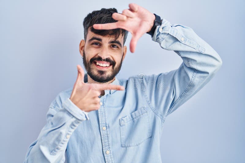 Young Hispanic Man with Beard Standing Over Blue Background Smiling ...