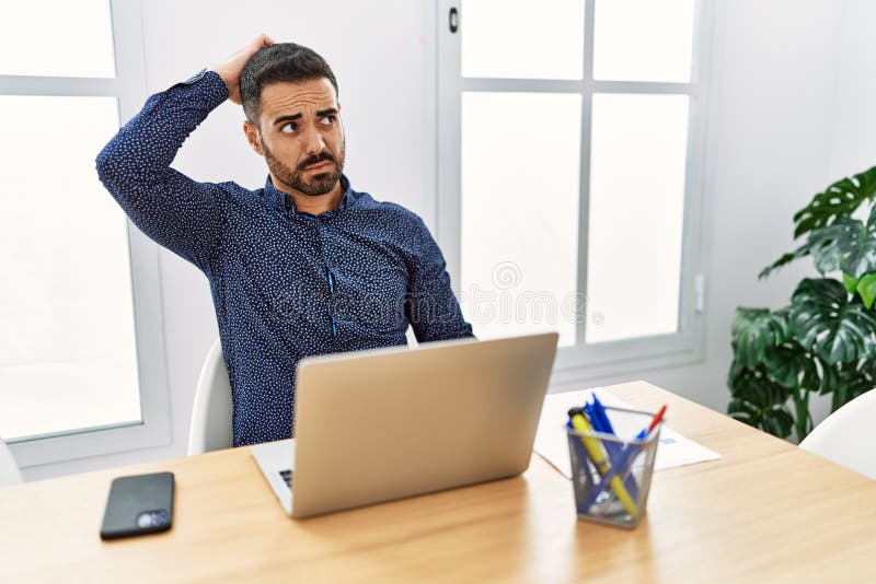 Young Hispanic Man with Beard Working at the Office with Laptop Confuse ...