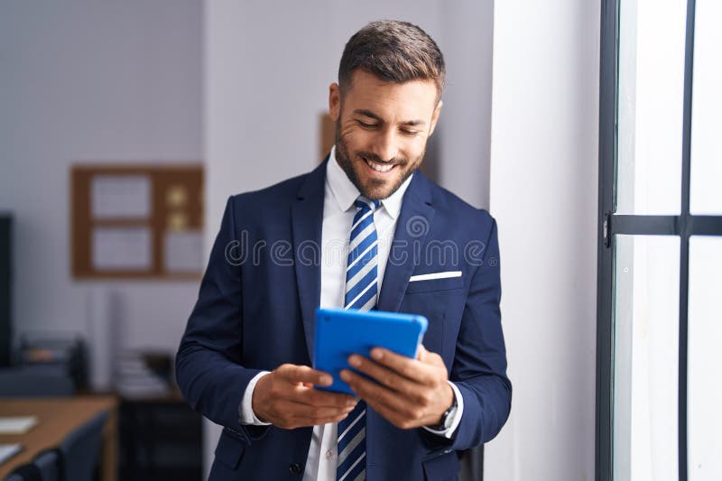 Young Hispanic Man Business Worker Smiling Confident Using Touchpad at ...