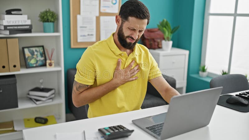 Young Hispanic Man Business Worker Suffering Heart Attack Working at ...
