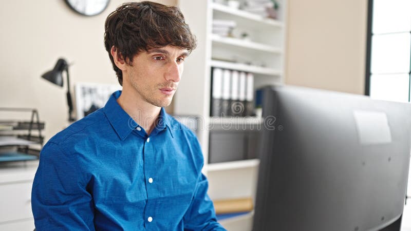 Young Hispanic Man Business Worker Using Computer Working at the Office ...