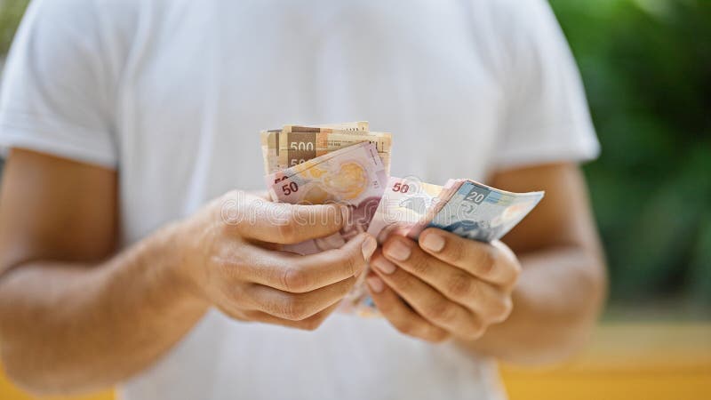 Young Hispanic Man Counting Mexican Pesos at Park Stock Image - Image ...