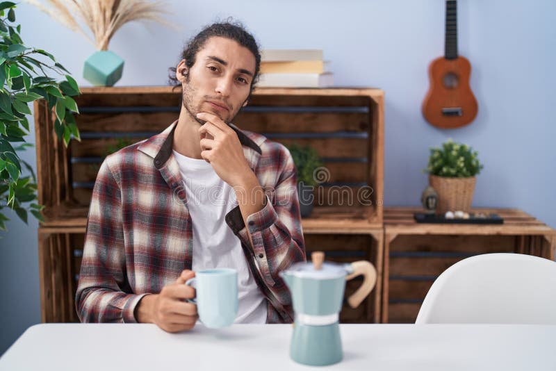 Young Hispanic Man Drinking Coffee from French Coffee Maker Serious ...