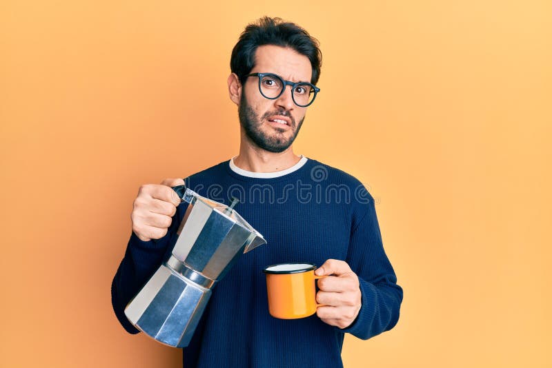 Young Hispanic Man Drinking Italian Coffee Clueless and Confused ...