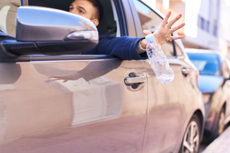 Young Hispanic Man Driving Car Throwing Plastic Bottle at Street Stock ...